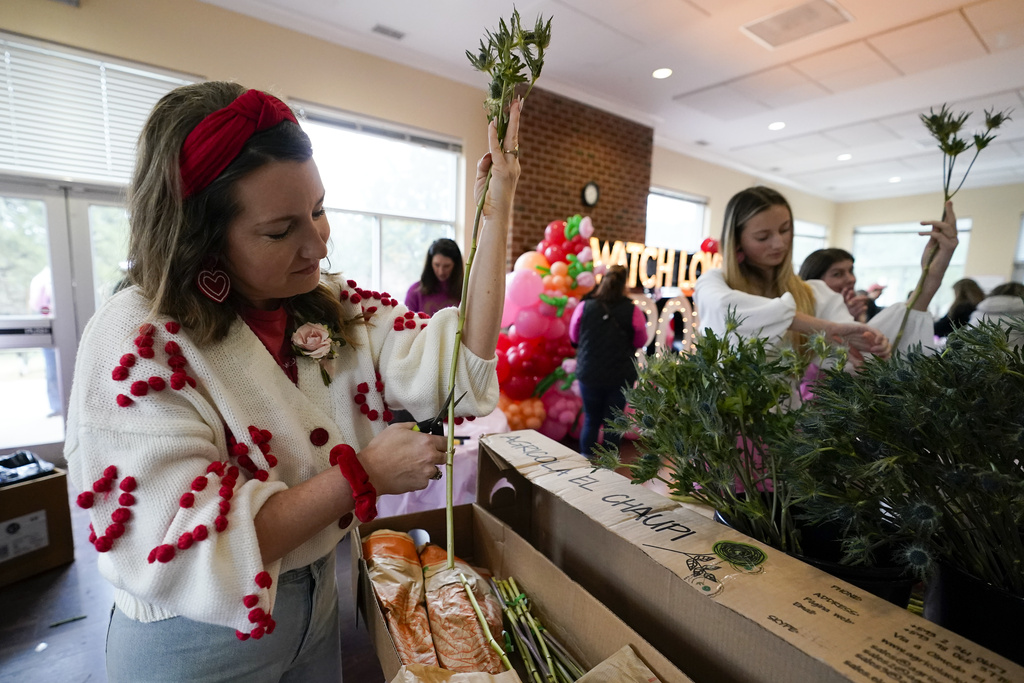 Volunteers deliver gifts to widows on Valentine’s Day. The project ...